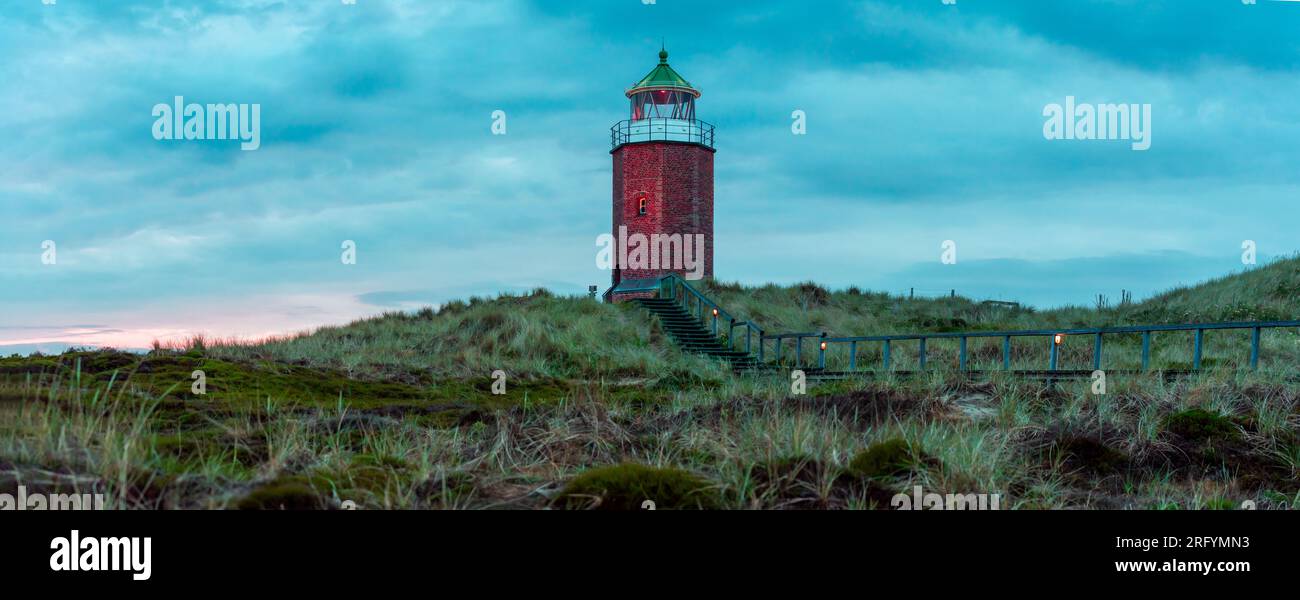 Sunset panorama landscape on Sylt Island with a red lighthouse on top ...