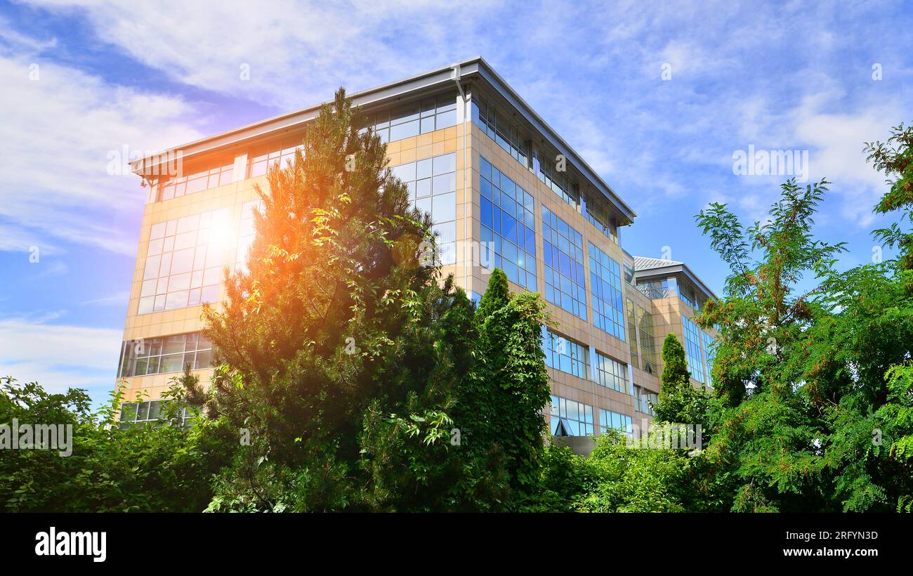 Eco building in modern city concept. Fresh green trees and office ...