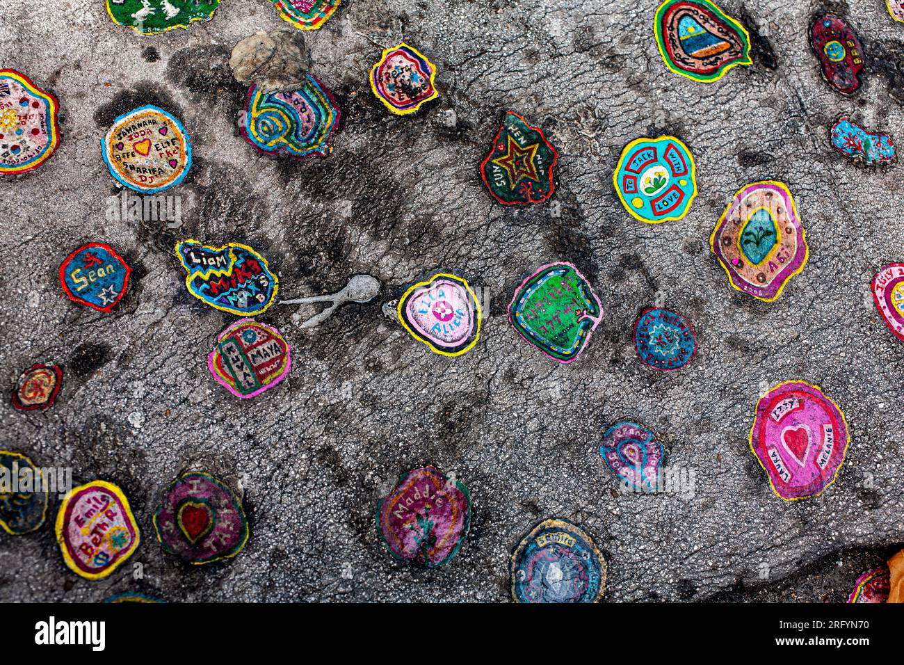 London, UK. Tiny work of art painted on a discarded piece of chewing ...