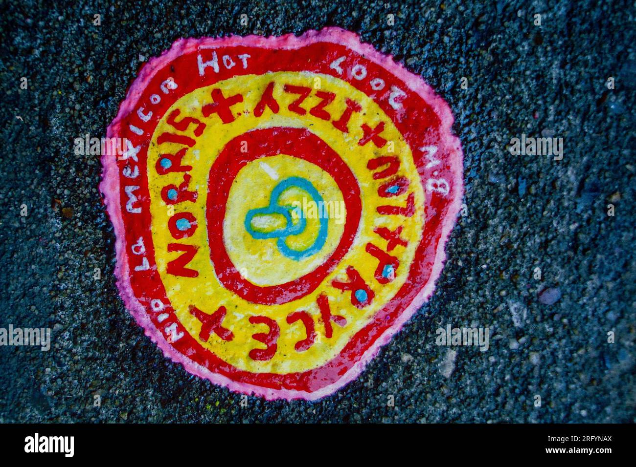 London, UK. Tiny work of art painted on a discarded piece of chewing ...