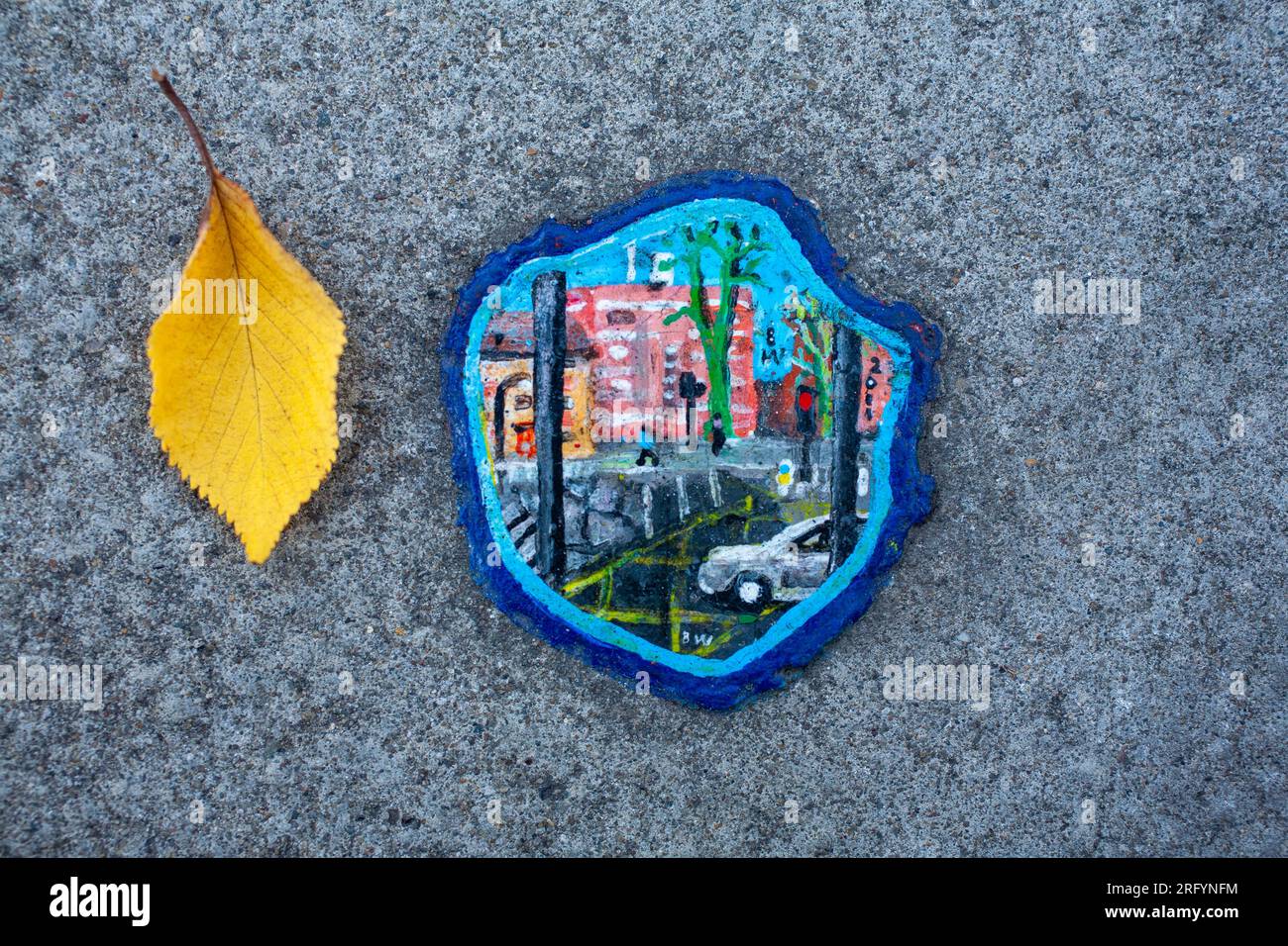 London, UK. Tiny work of art painted on a discarded piece of chewing ...