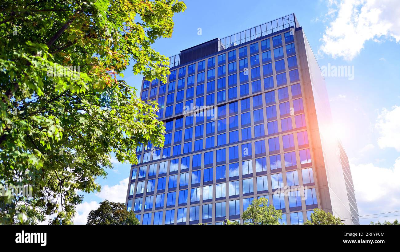 Eco building in modern city concept. Fresh green trees and office ...
