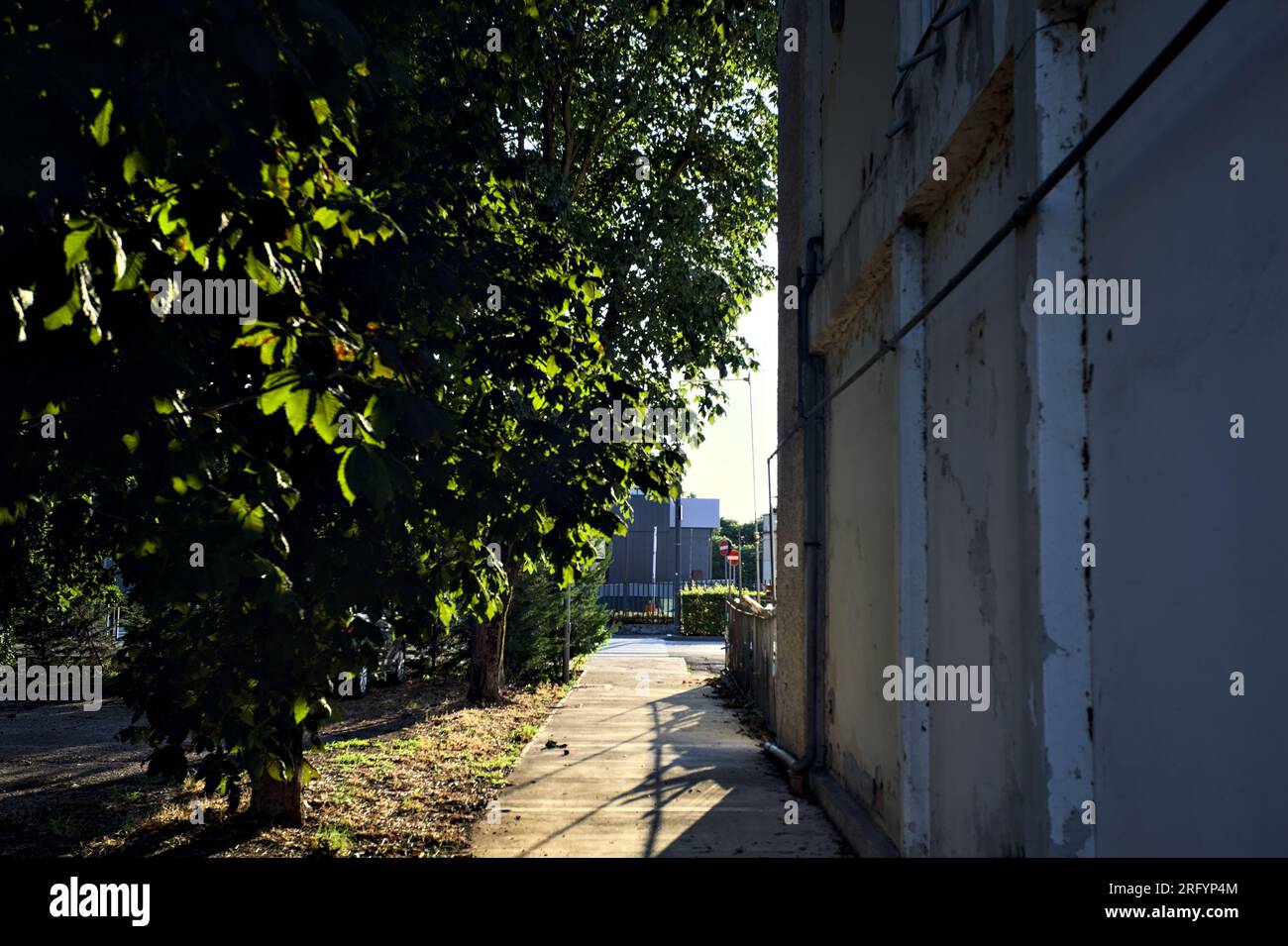 Gravel path in a park next to a building that leads to a pedestrian ...
