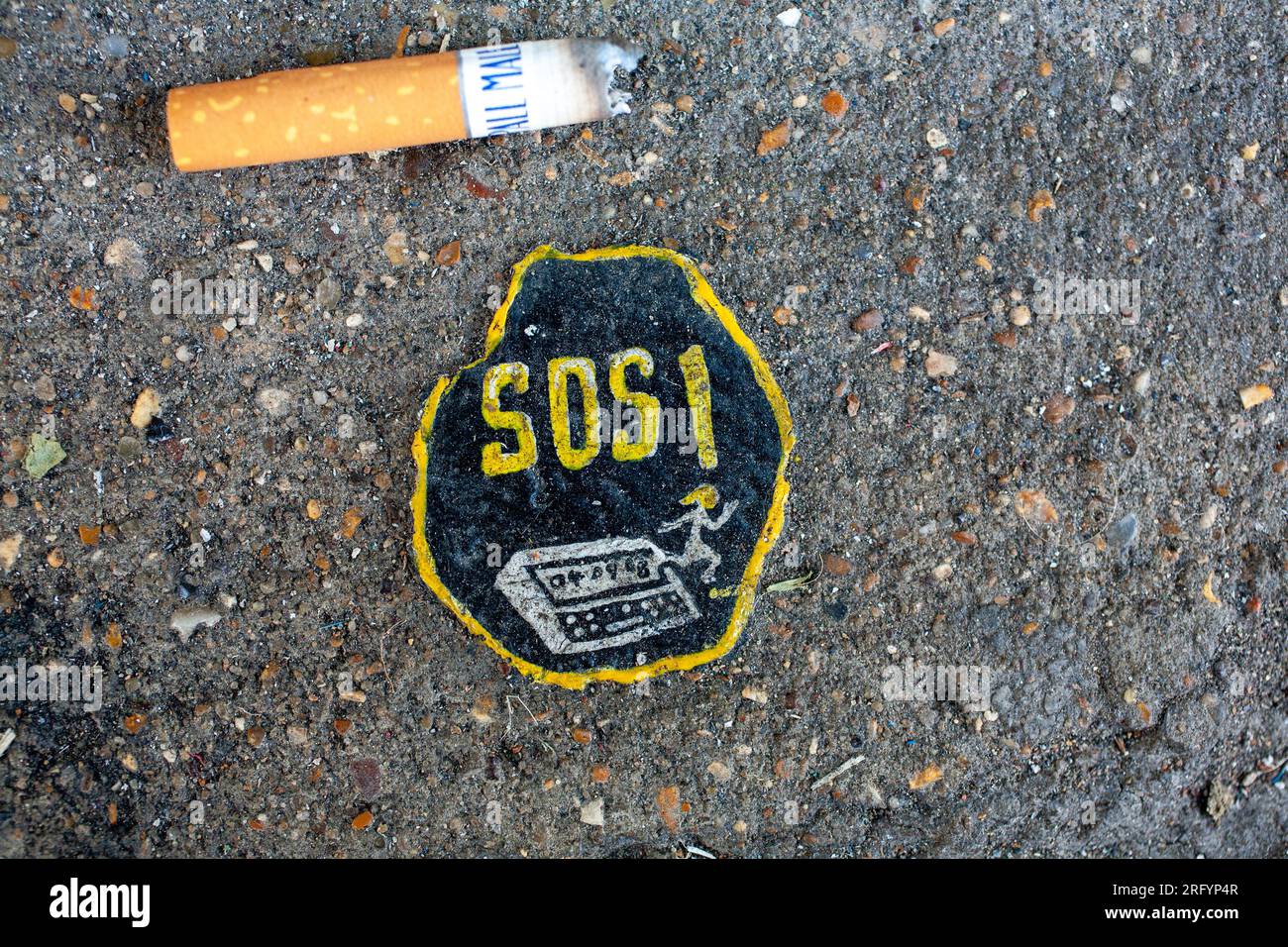 London, UK. Tiny work of art painted on a discarded piece of chewing ...
