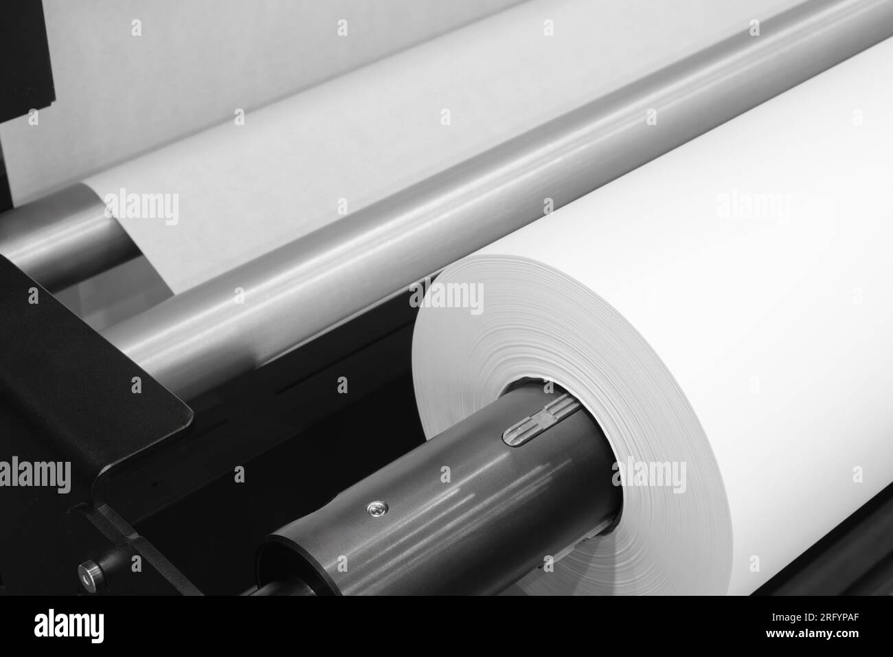 Rolls paper and fabric in wide industrial plotter Stock Photo - Alamy