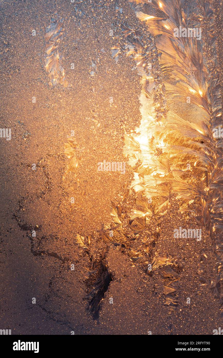 Fire and Ice, Sun shining through ice covered window in Winter Stock ...