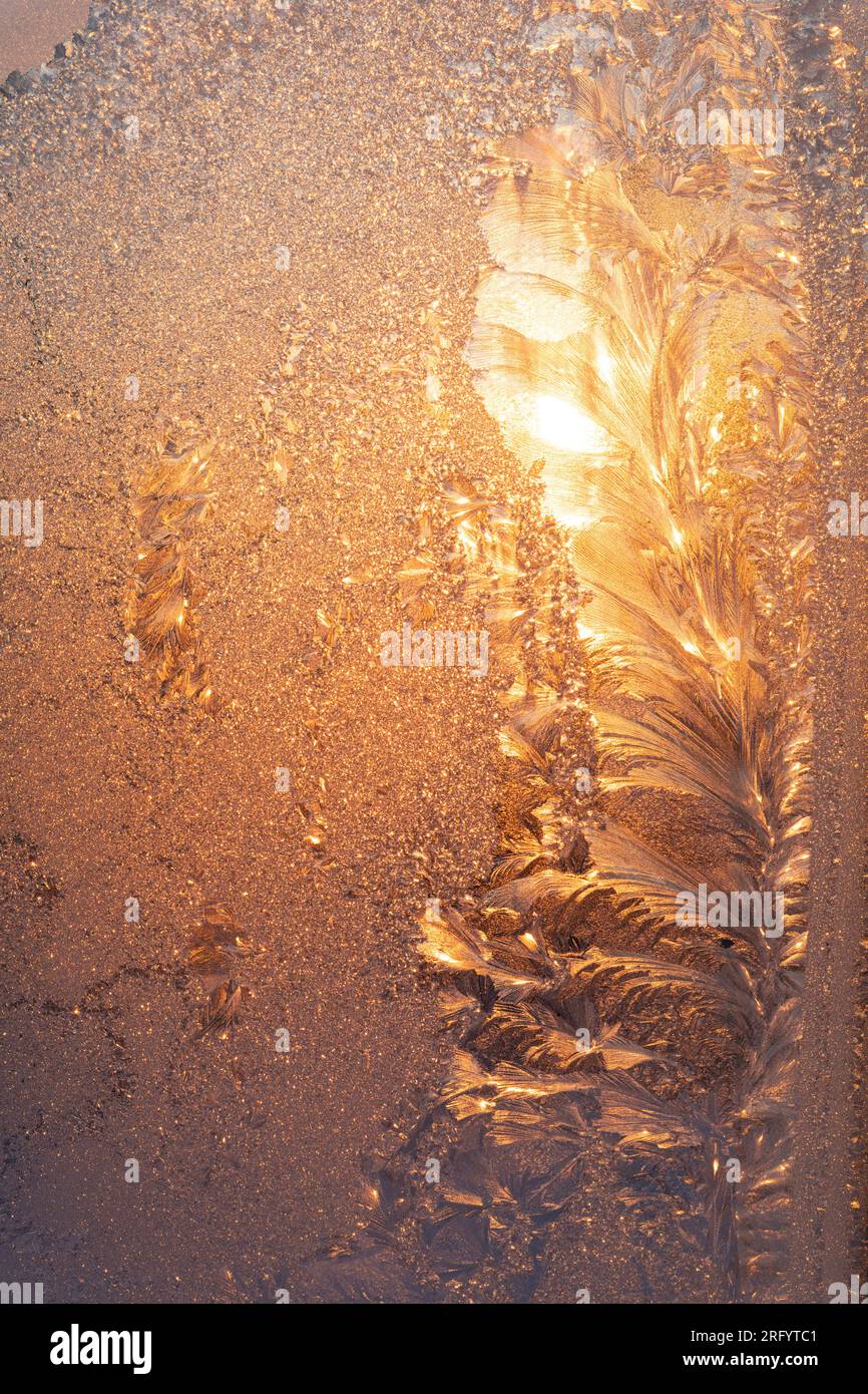 Fire and Ice, Sun shining through ice covered window in Winter Stock ...
