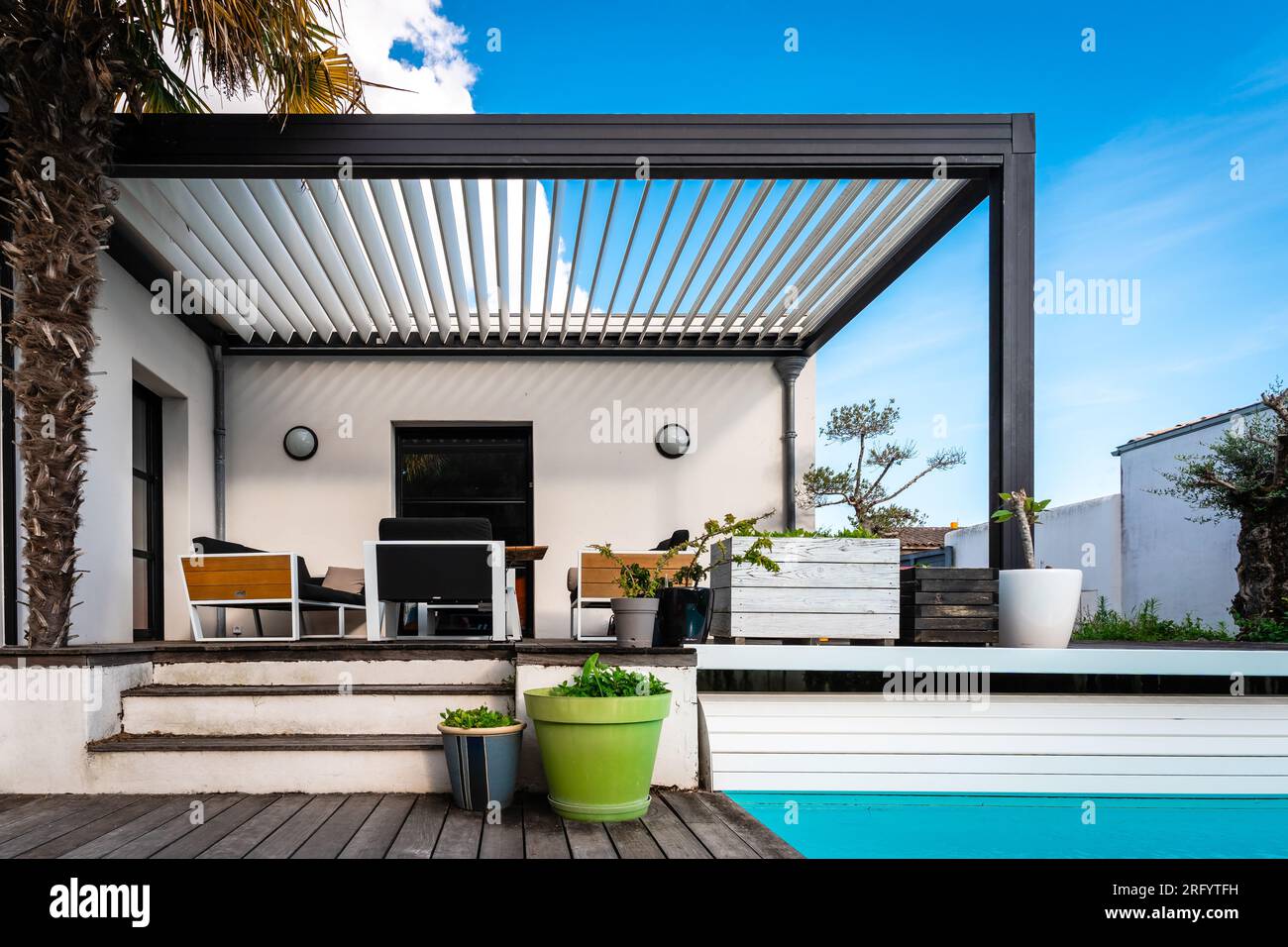 modern pergola structure in a contemporary house surrounded by a garden ...