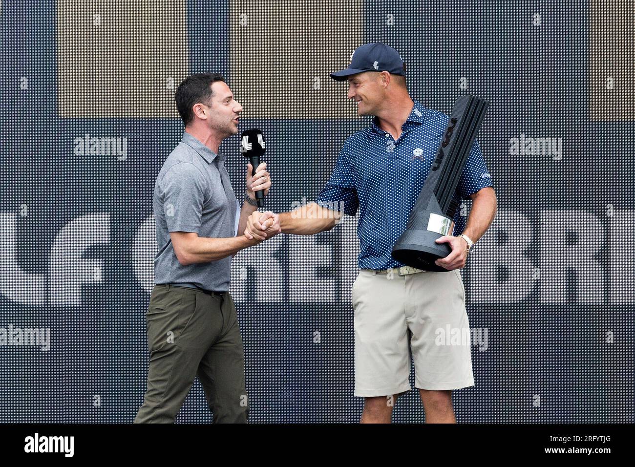 LIV Golf Announcer, Jason Zone Fisher shakes hands with Captain Bryson ...