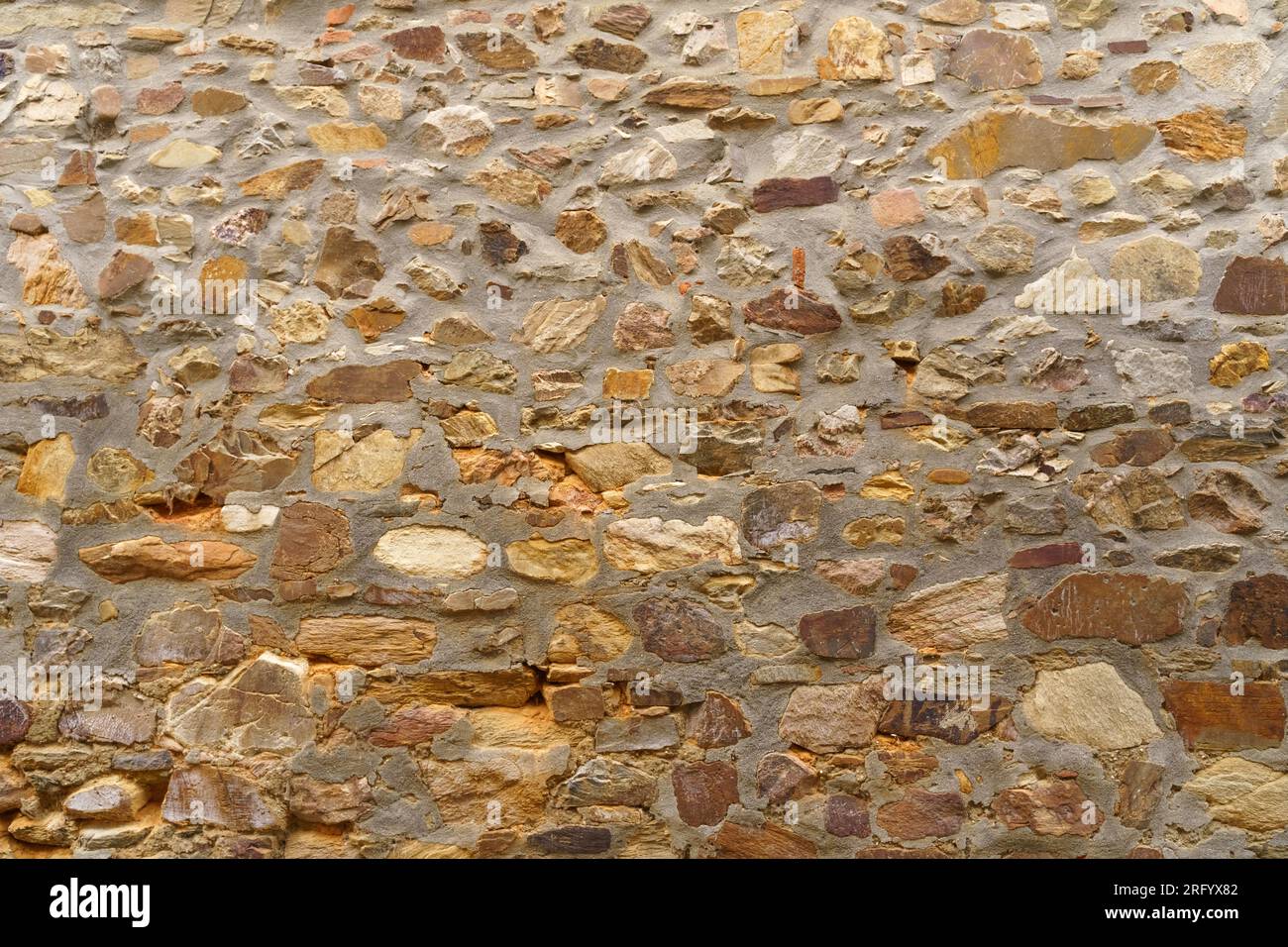 The texture of the old medieval wall of the house, lined with brown ...