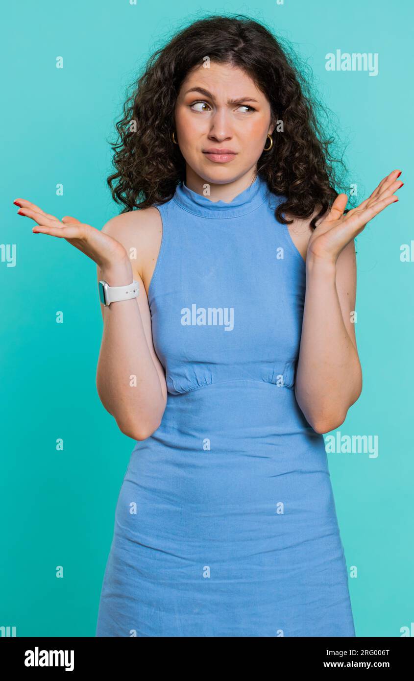 What Why. Sincere irritated young woman raising hands in indignant expression, ask reason of ...