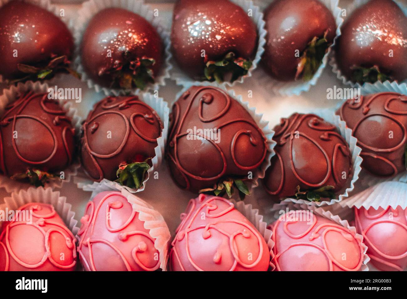 Details of pink chocolate covered strawberries. Candies sweets collection. Tasty set for ...
