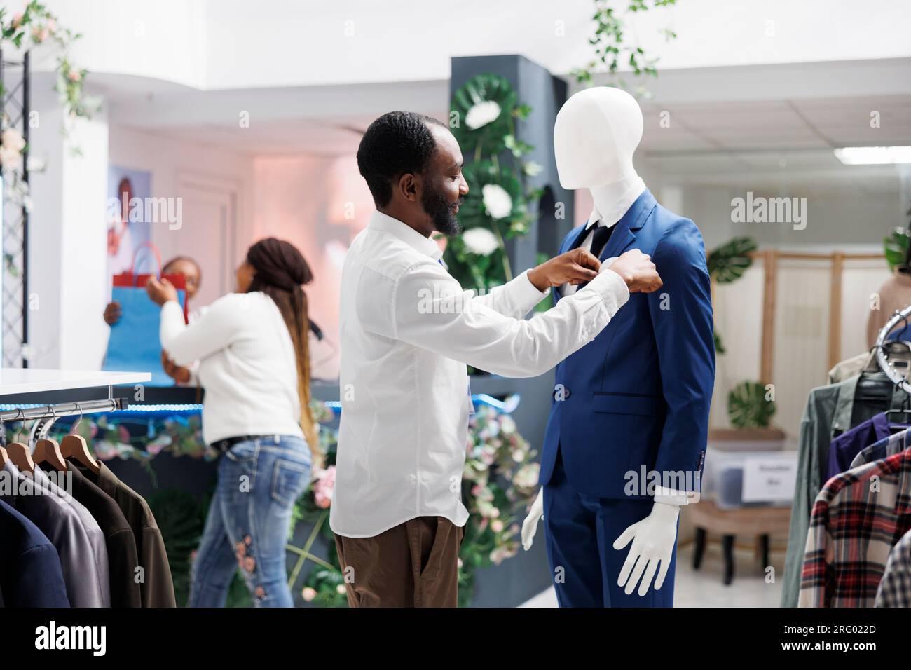 African american man dressing mannequing in formal male outfit in ...