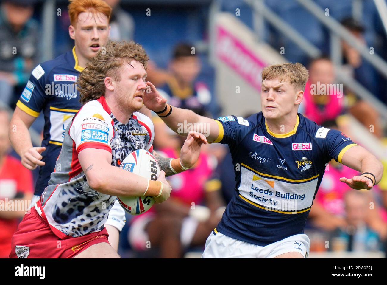 James McDonnell #19 of Leeds Rhinos stretches to tackle Tom Nisbet #22 ...