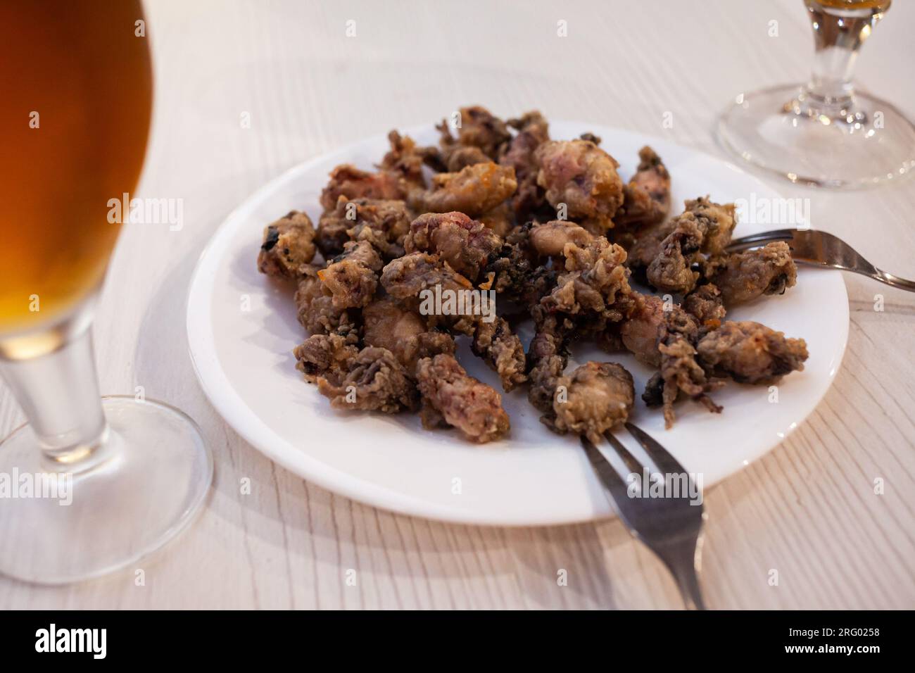 Chipirones, breaded fried calamari with lemon Stock Photo - Alamy