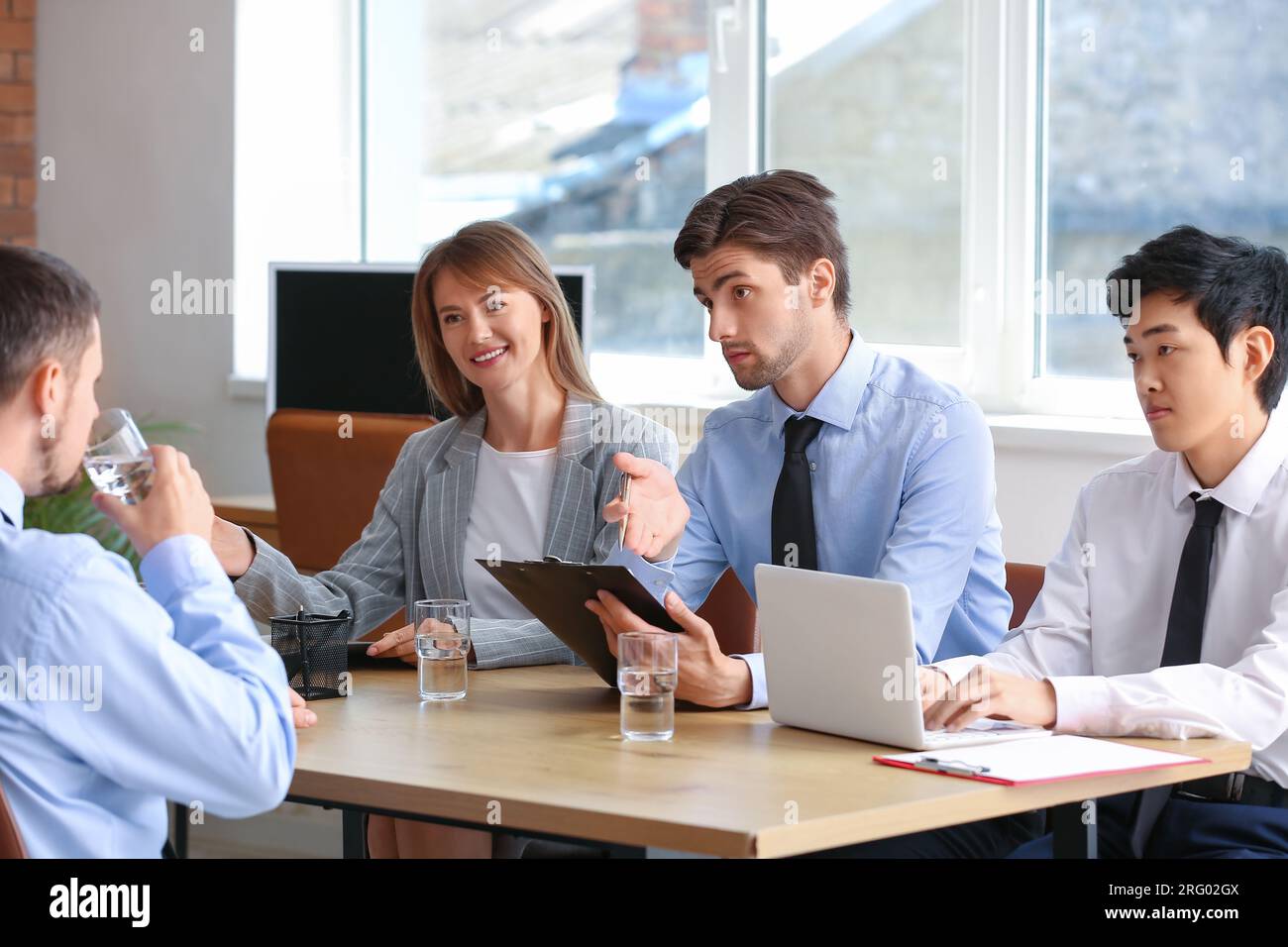 Human resources commission interviewing male applicant in office Stock ...