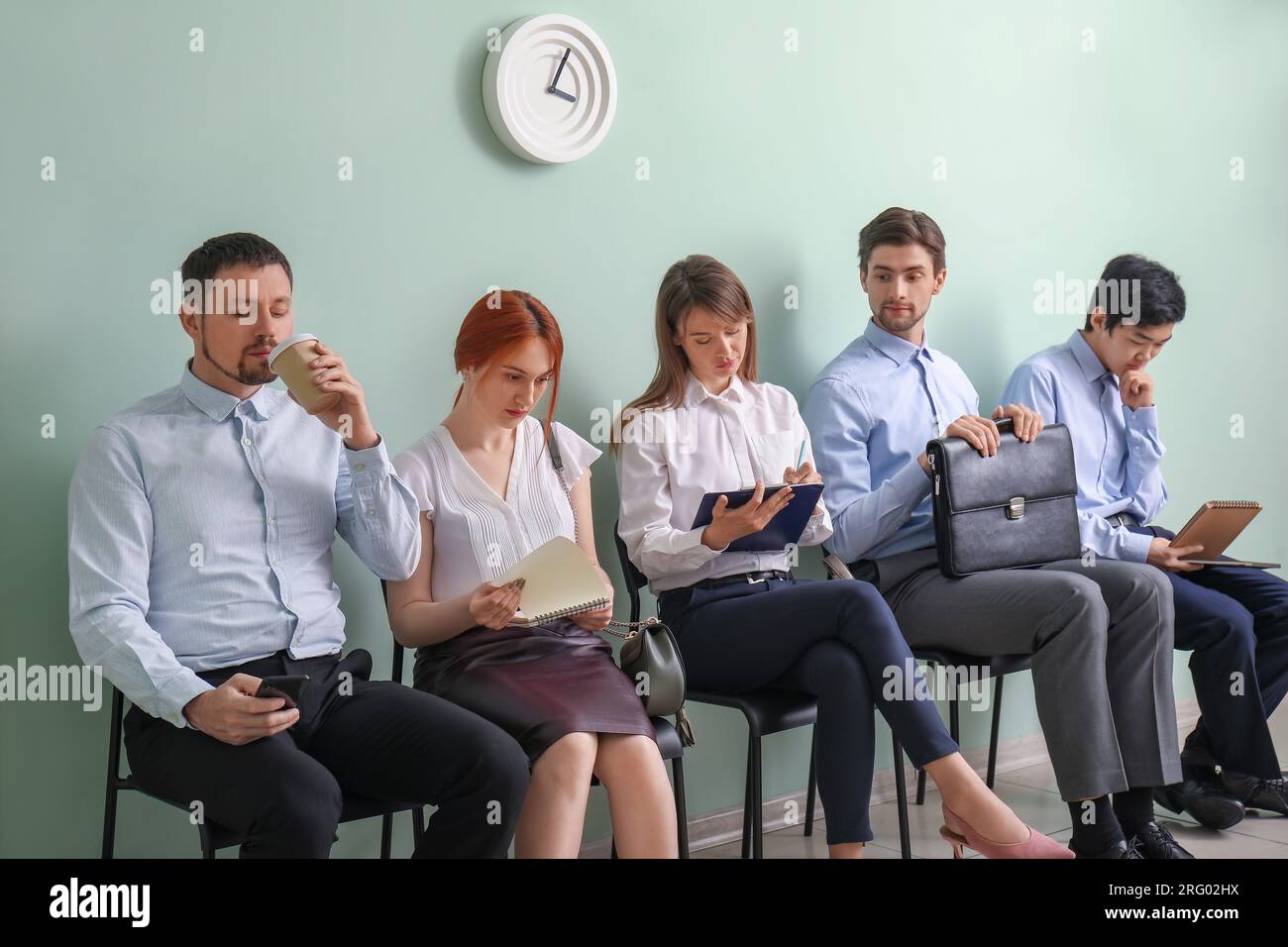 Young applicants waiting for job interview in room Stock Photo - Alamy