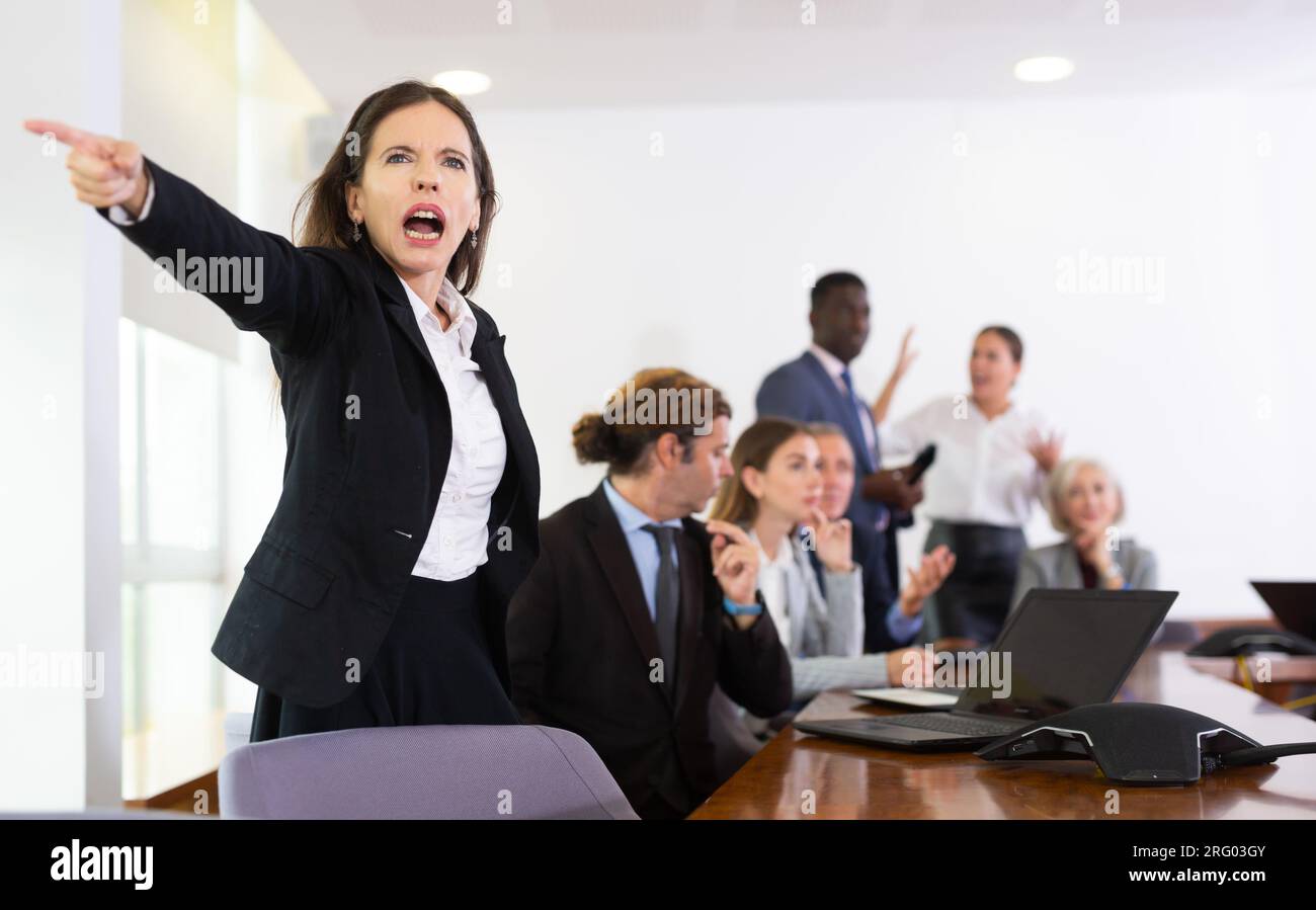 Angry businesswoman shouting during meeting Stock Photo - Alamy