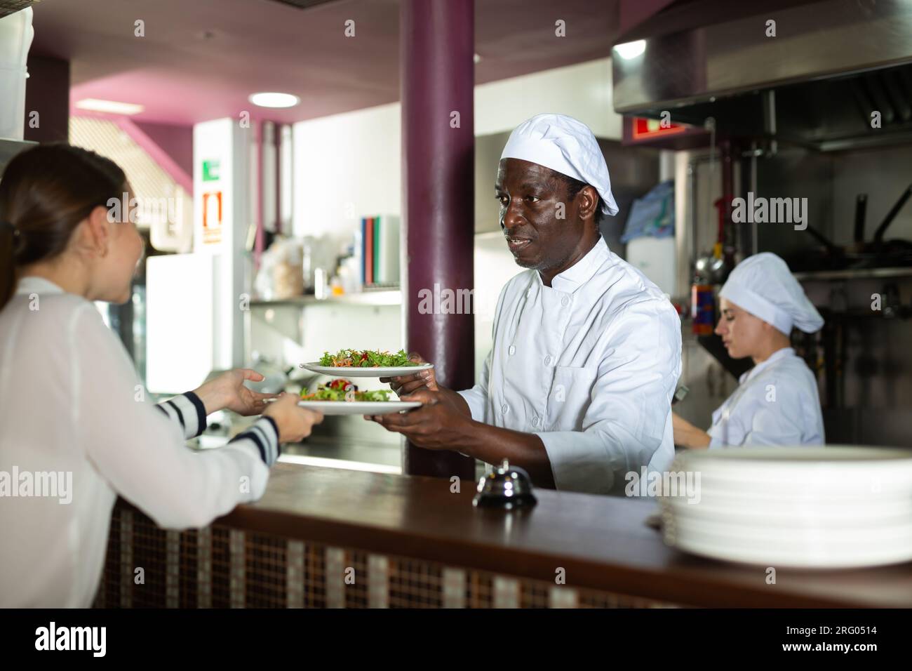 Chef handing food dish waitress hi-res stock photography and images - Alamy