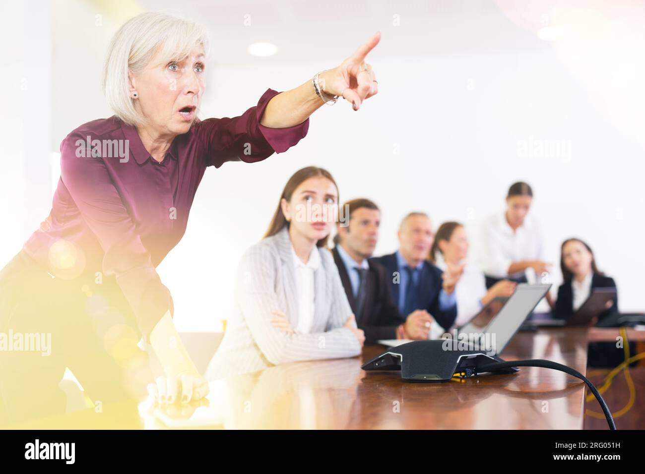 Irritated boss scolding associates, pointing out shortcomings and ...