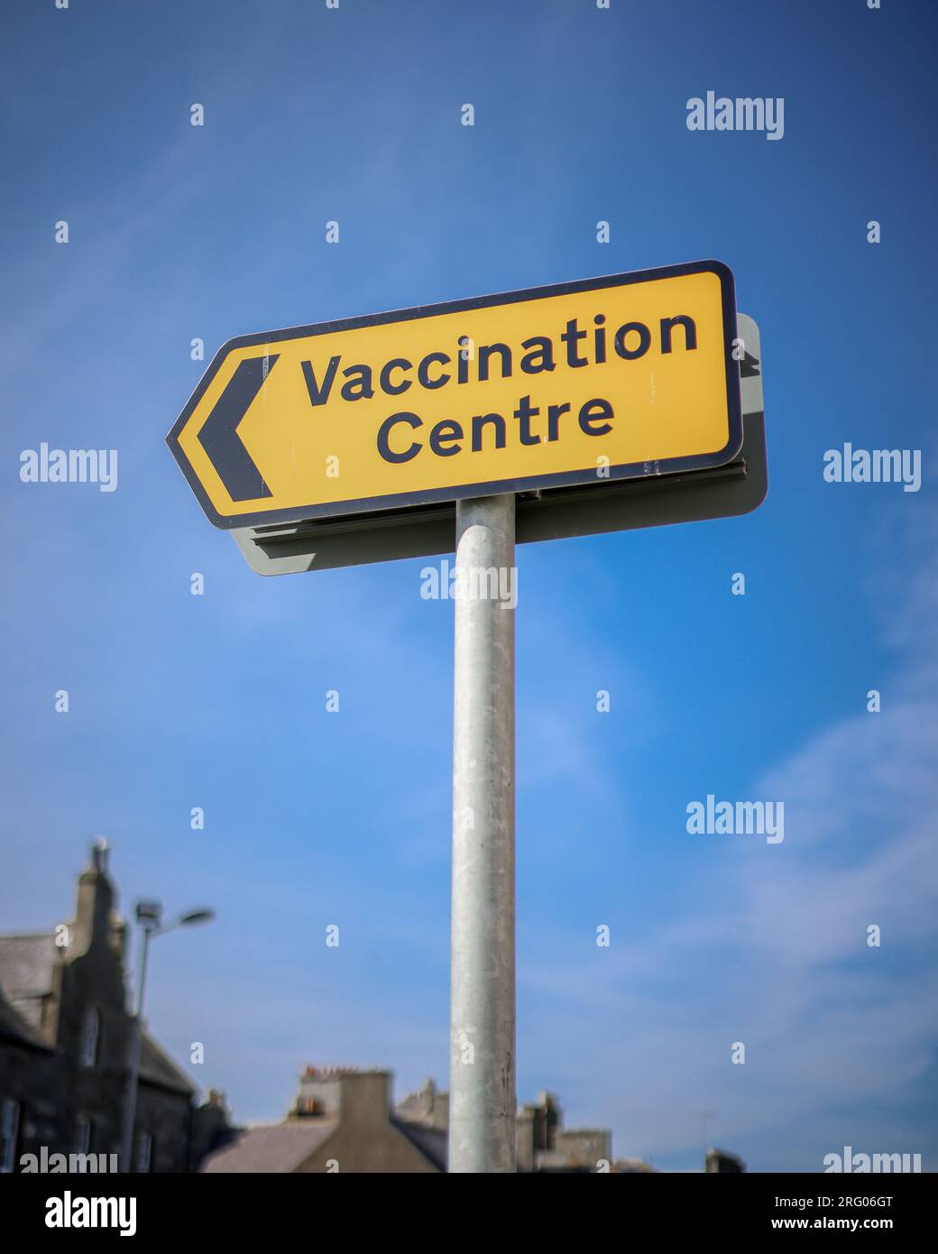 Picture of a covid-19 coronavirus yellow vaccination sign on a blue sky ...