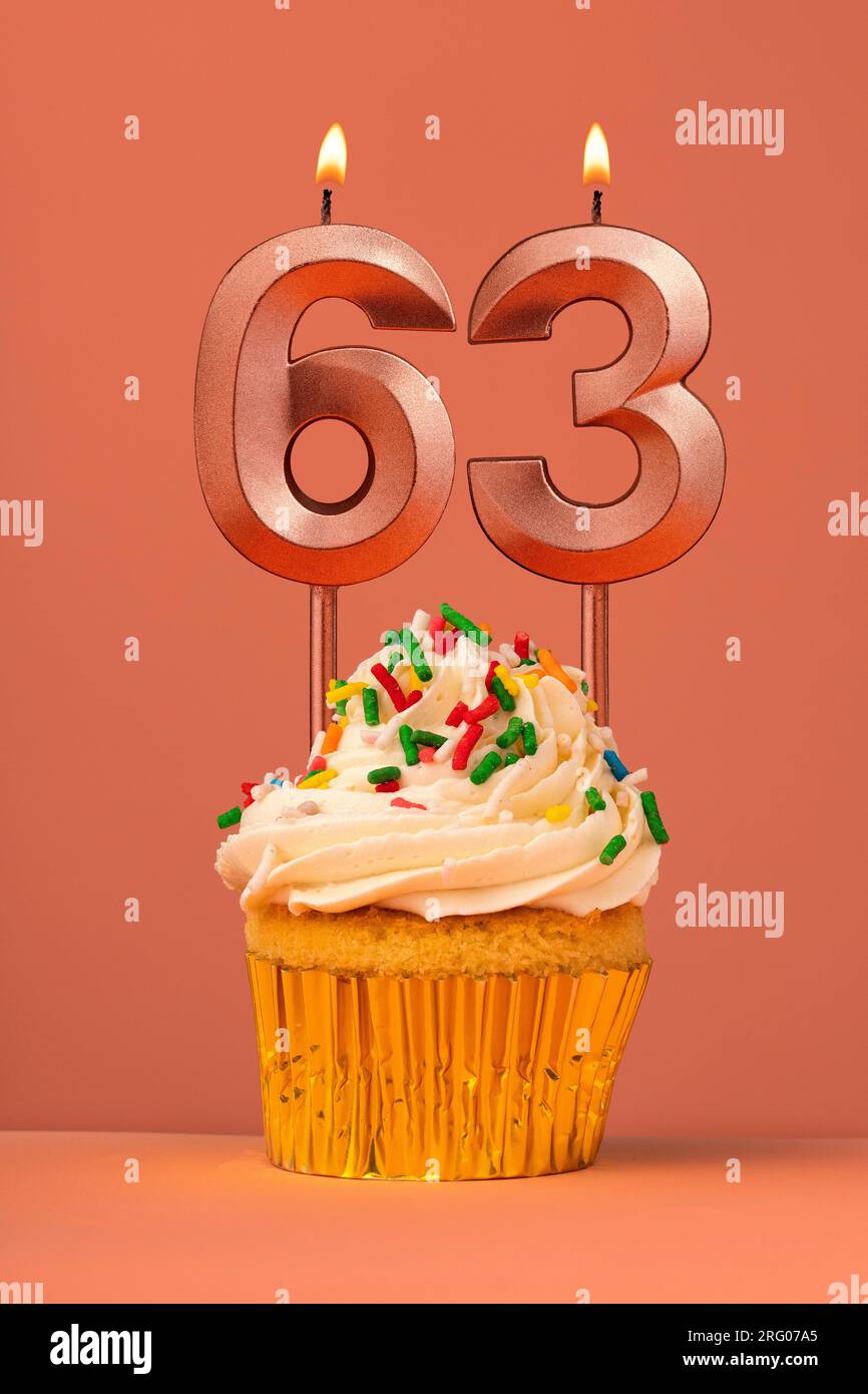 Birthday cake with candle number 63 - Coral fusion background Stock ...