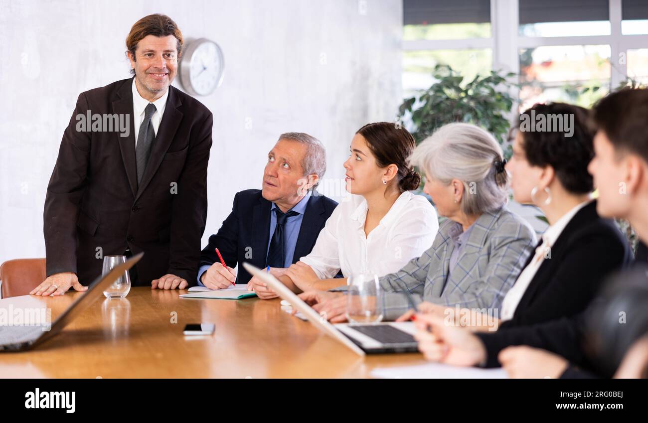 Man top manager standing and confidently speaking during corporate ...