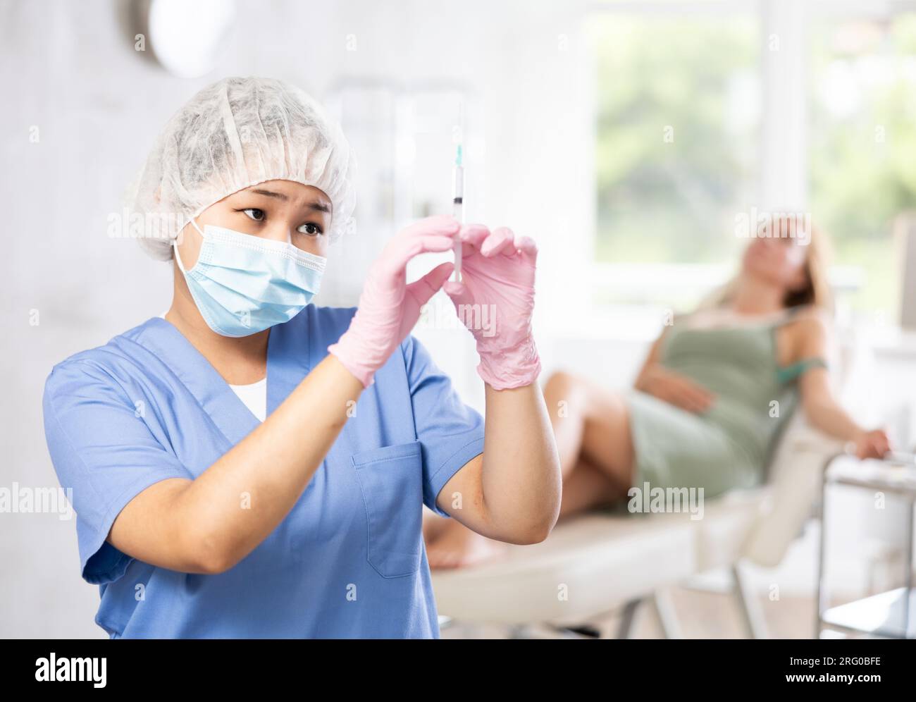 Doctor anesthetist checks the syringe before injection to patient Stock ...