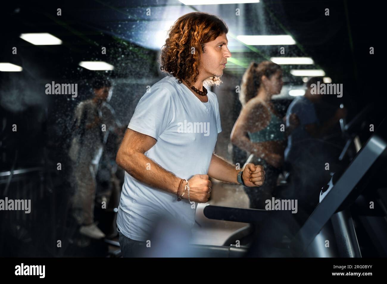 Adult man ldoing cardio workout on treadmill in gym Stock Photo - Alamy