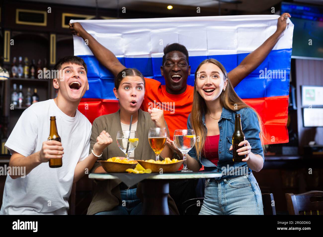 Happy friends of different ages drinking beer and celebrating the ...
