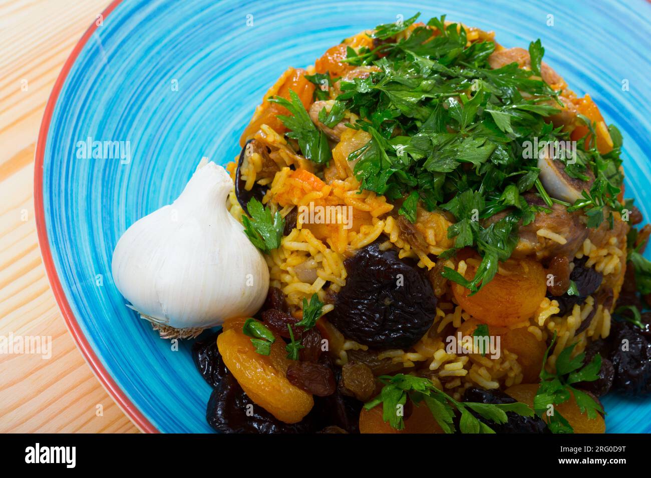 Lamb pilau with dried fruits and greens Stock Photo - Alamy