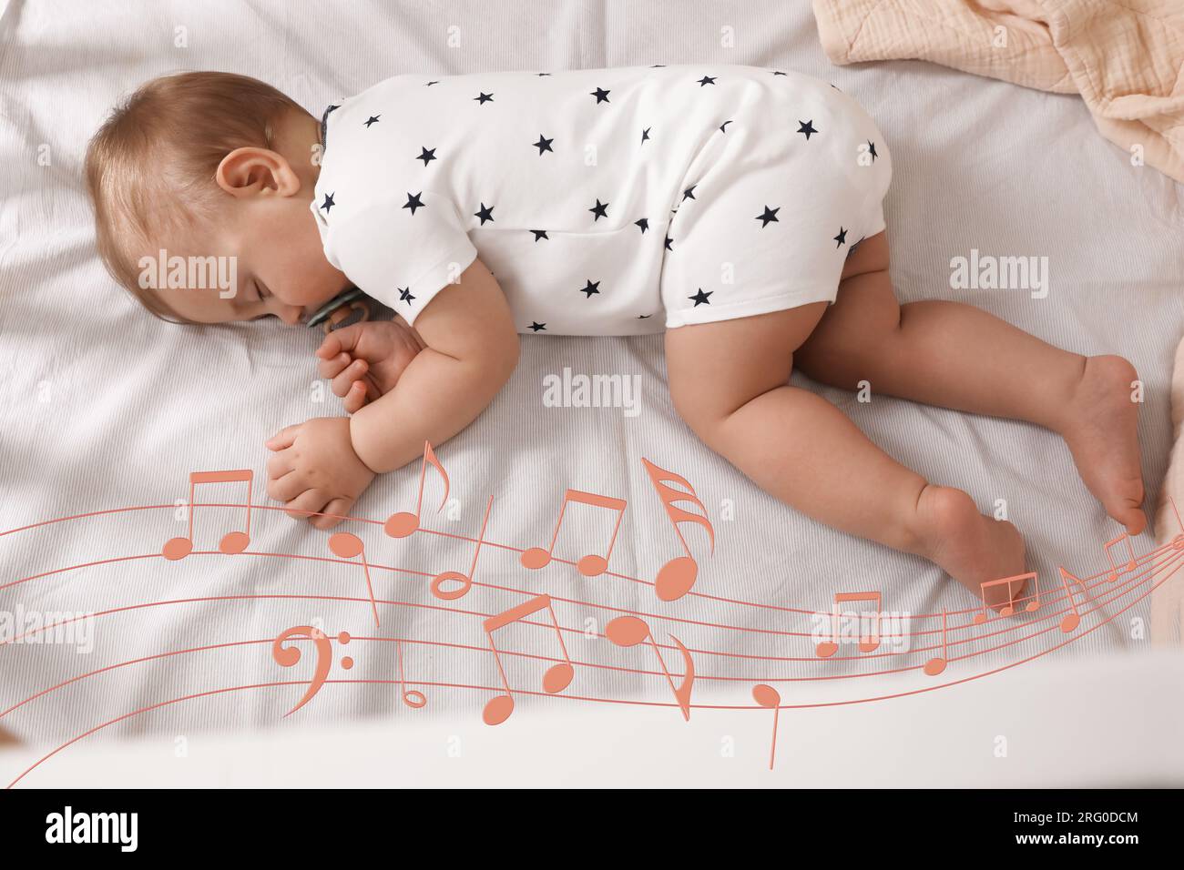 Lullaby songs. Cute little baby sleeping on bed, above view ...