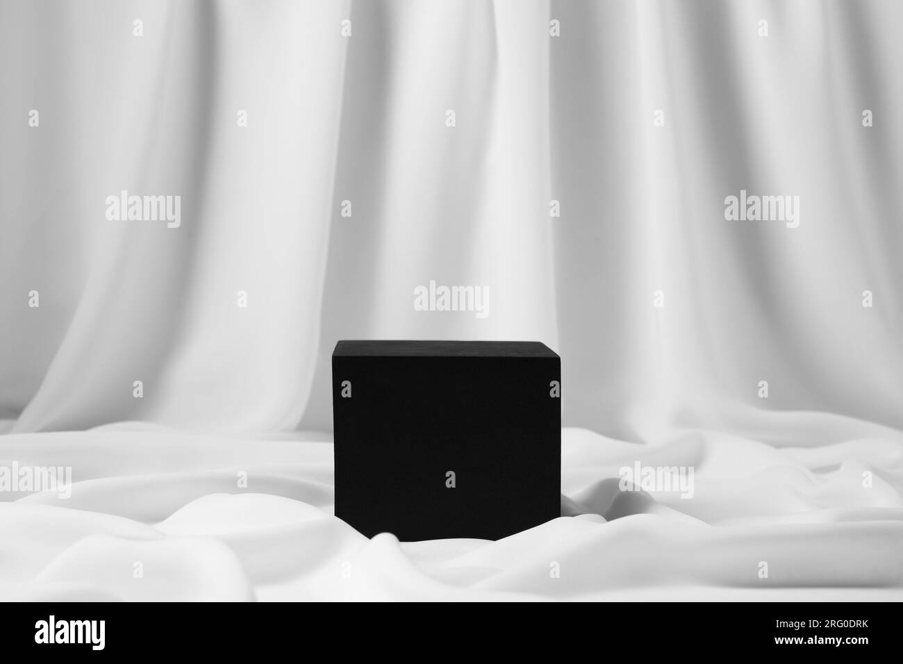 Black cube on white fabric. Stylish presentation for product Stock ...