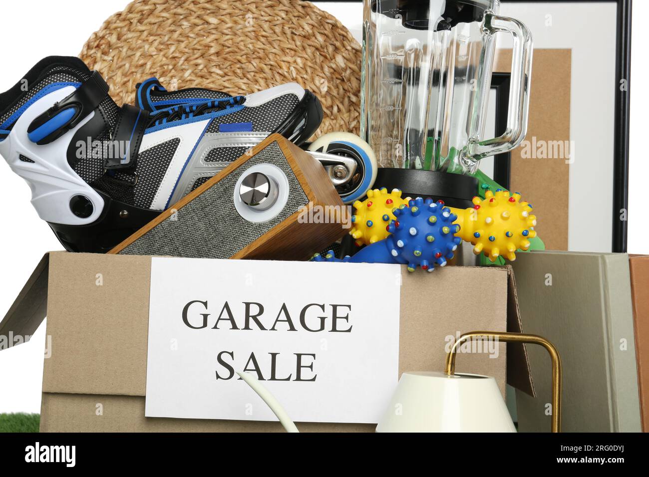Box with sign Garage Sale and different stuff against white background ...