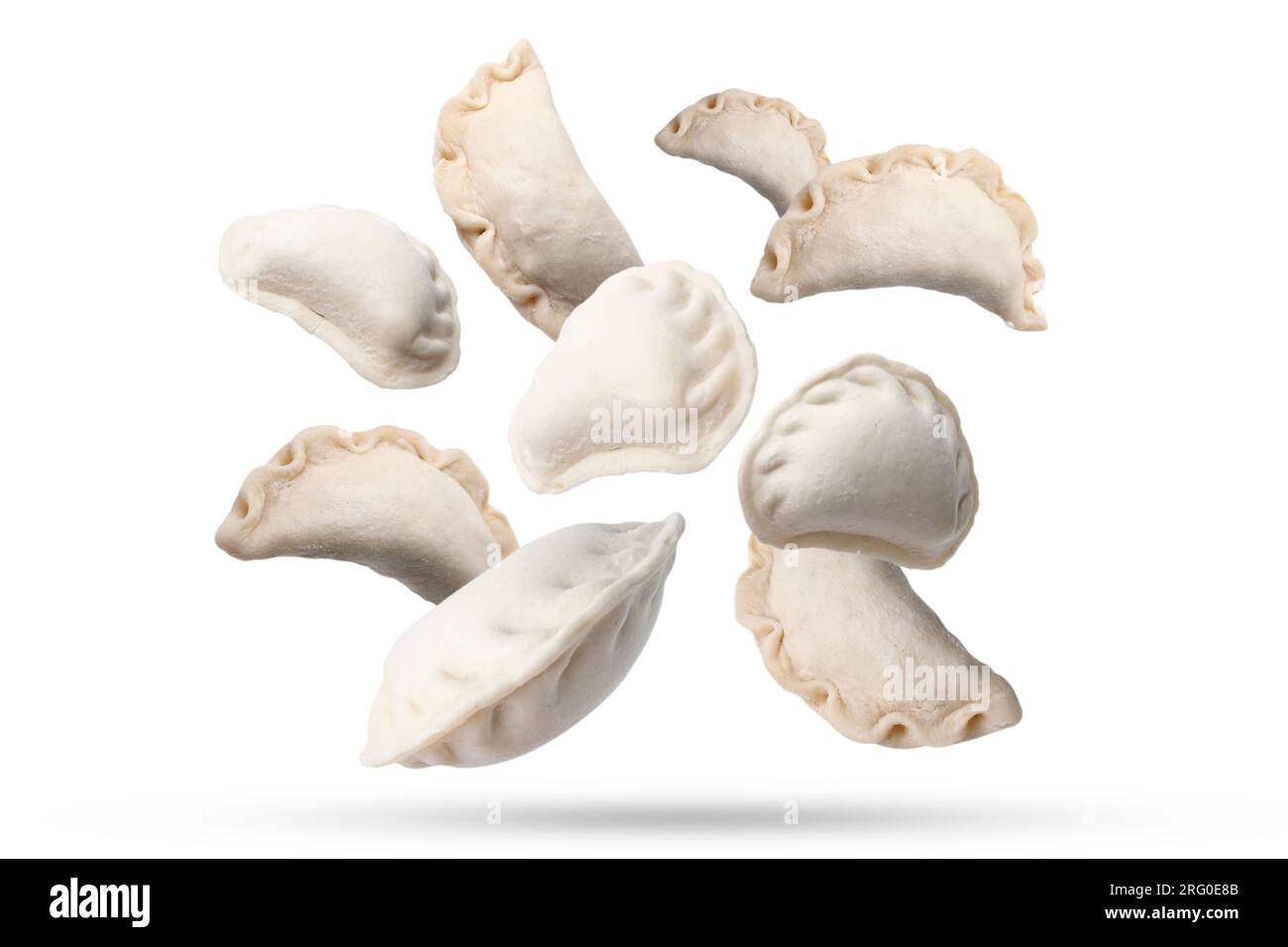 Many raw dumplings falling on white background Stock Photo - Alamy