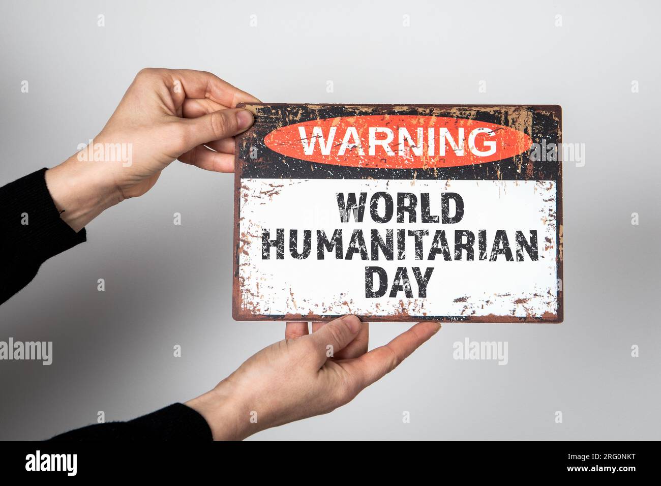 World Humanitarian Day 19 August. Warning sign with text on a white ...