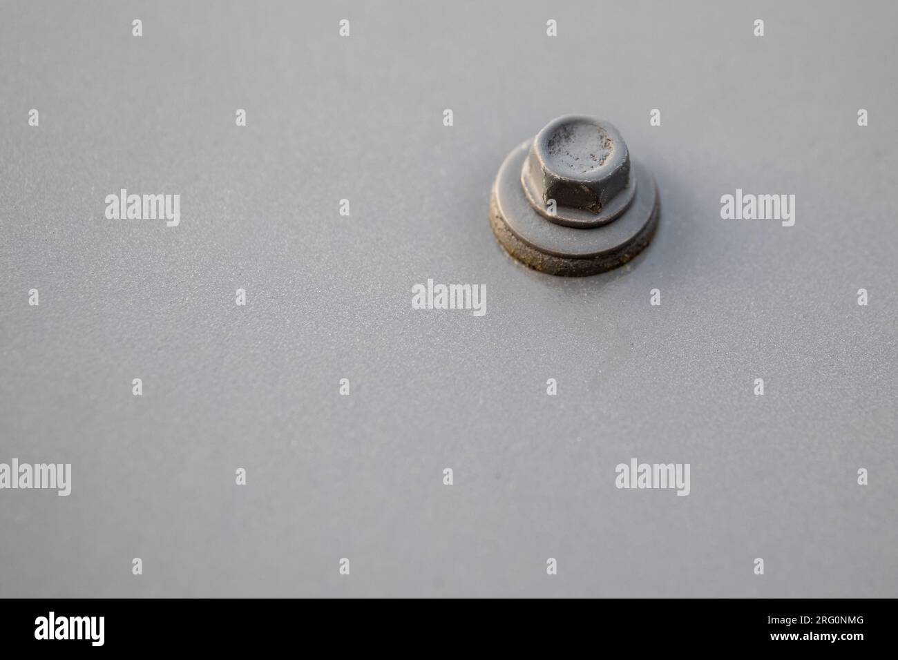 Top view of roofing screw. Gray metal roofing, installation and roofing ...