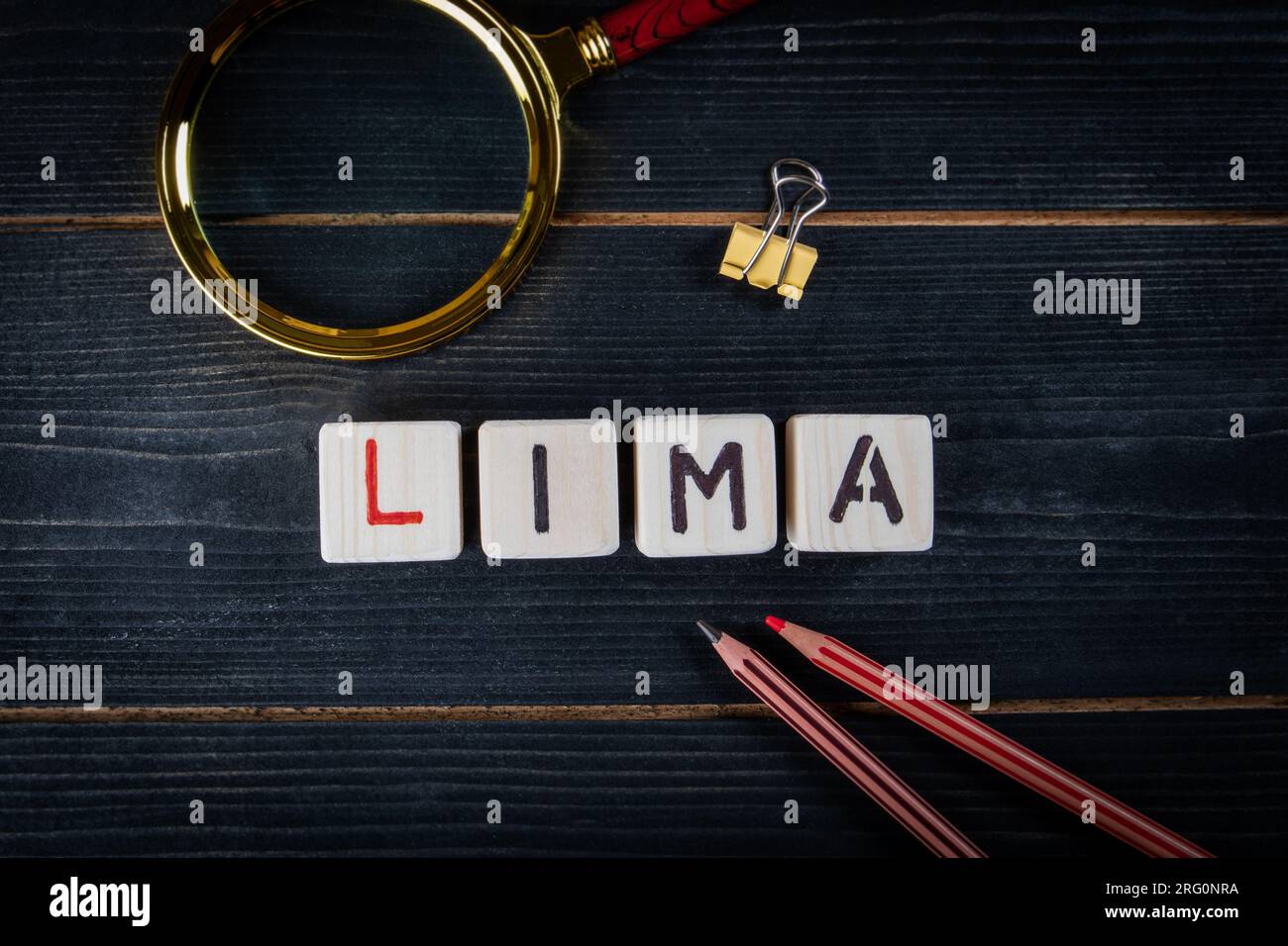 LIMA. City name from alphabet letters on dark wood texture background ...
