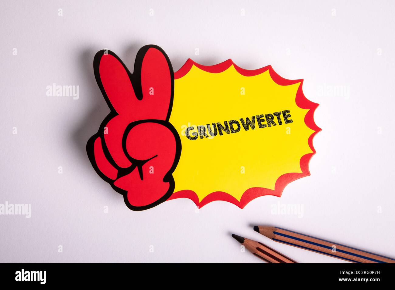 Core Values concept. Text in German on a sticky note. Colored pencils ...