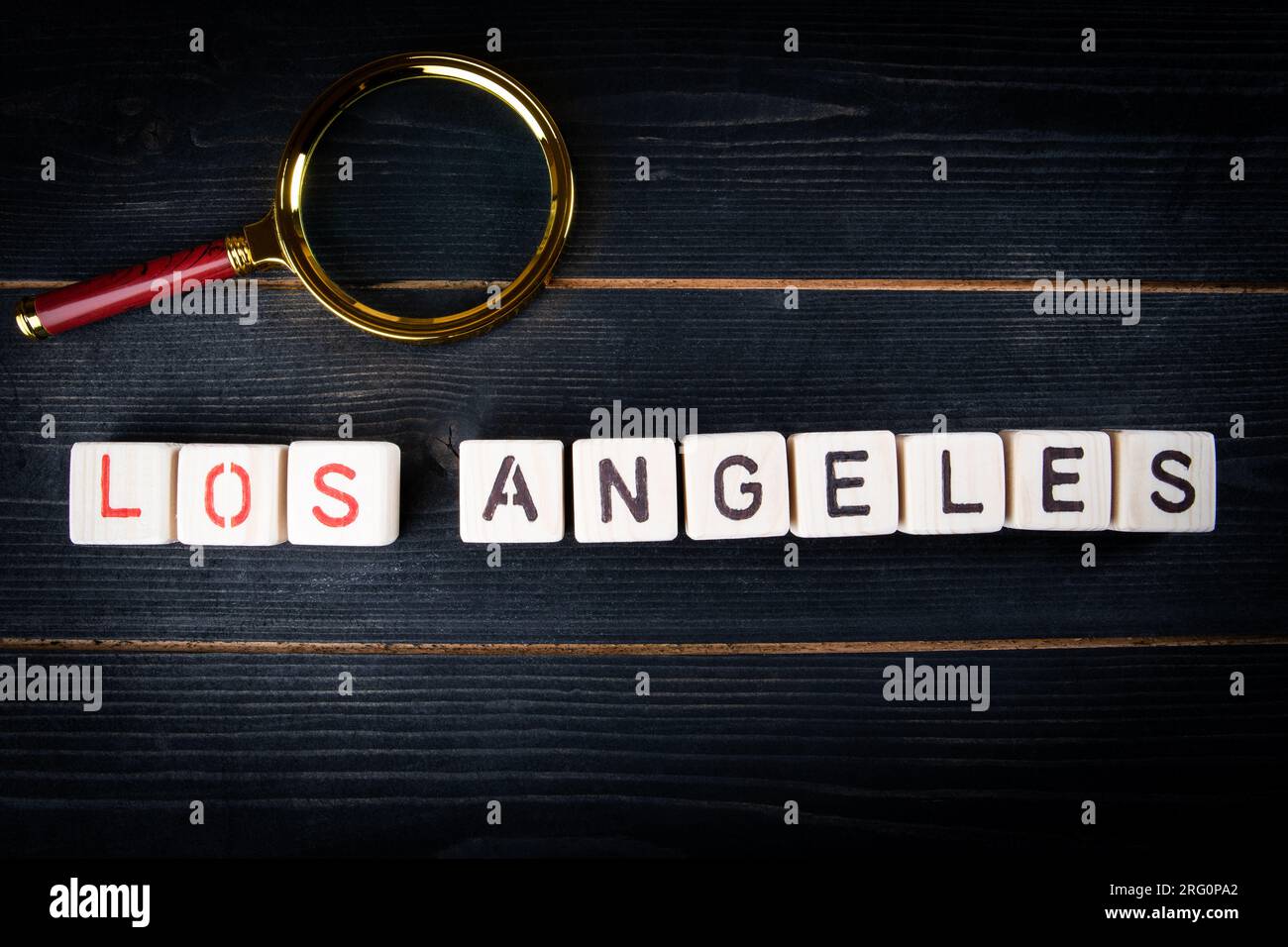 LOS ANGELES. City name from alphabet blocks on dark wood texture ...