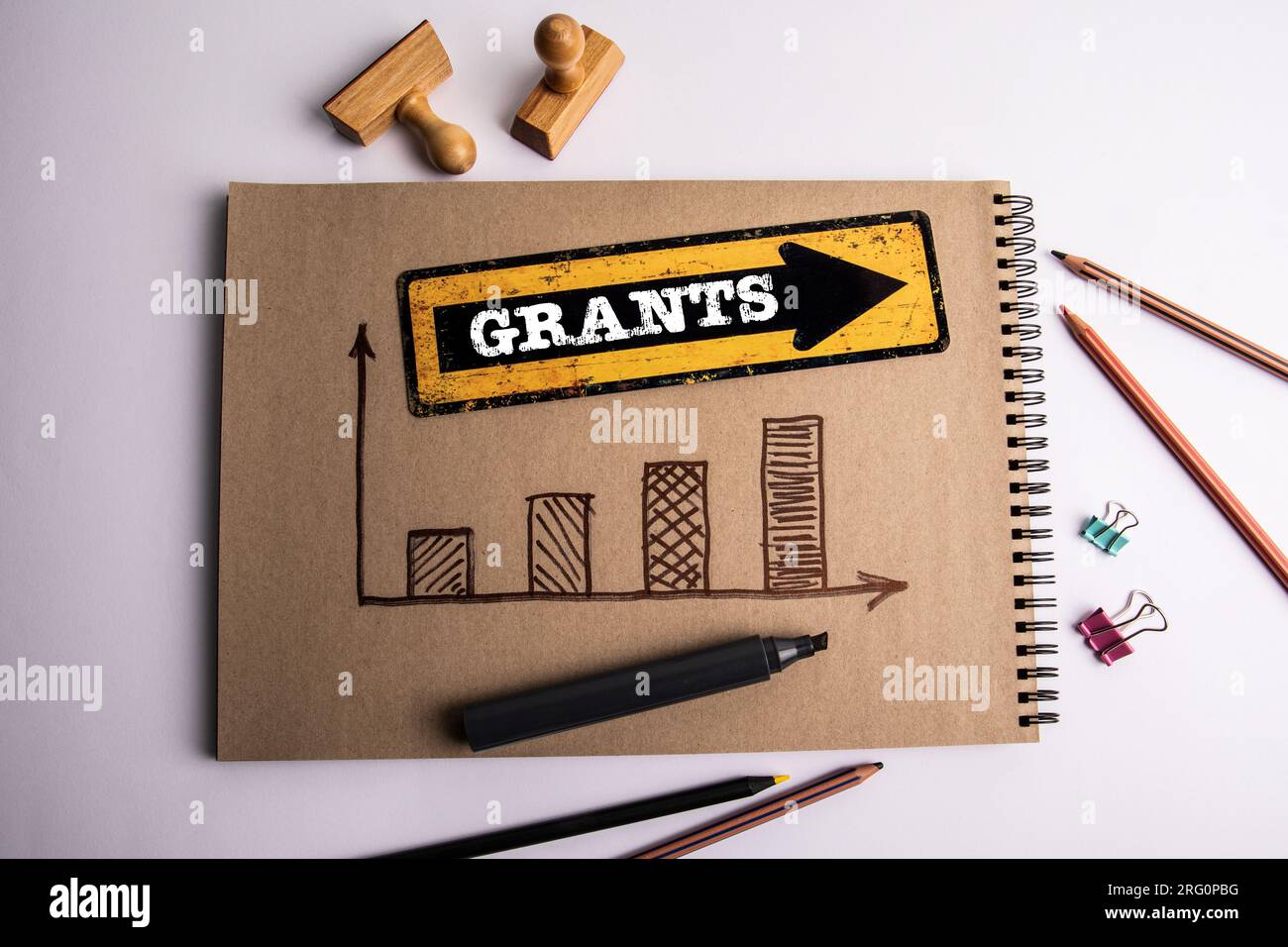 GRANTS. Text on the pointing arrow. Office items on white background ...