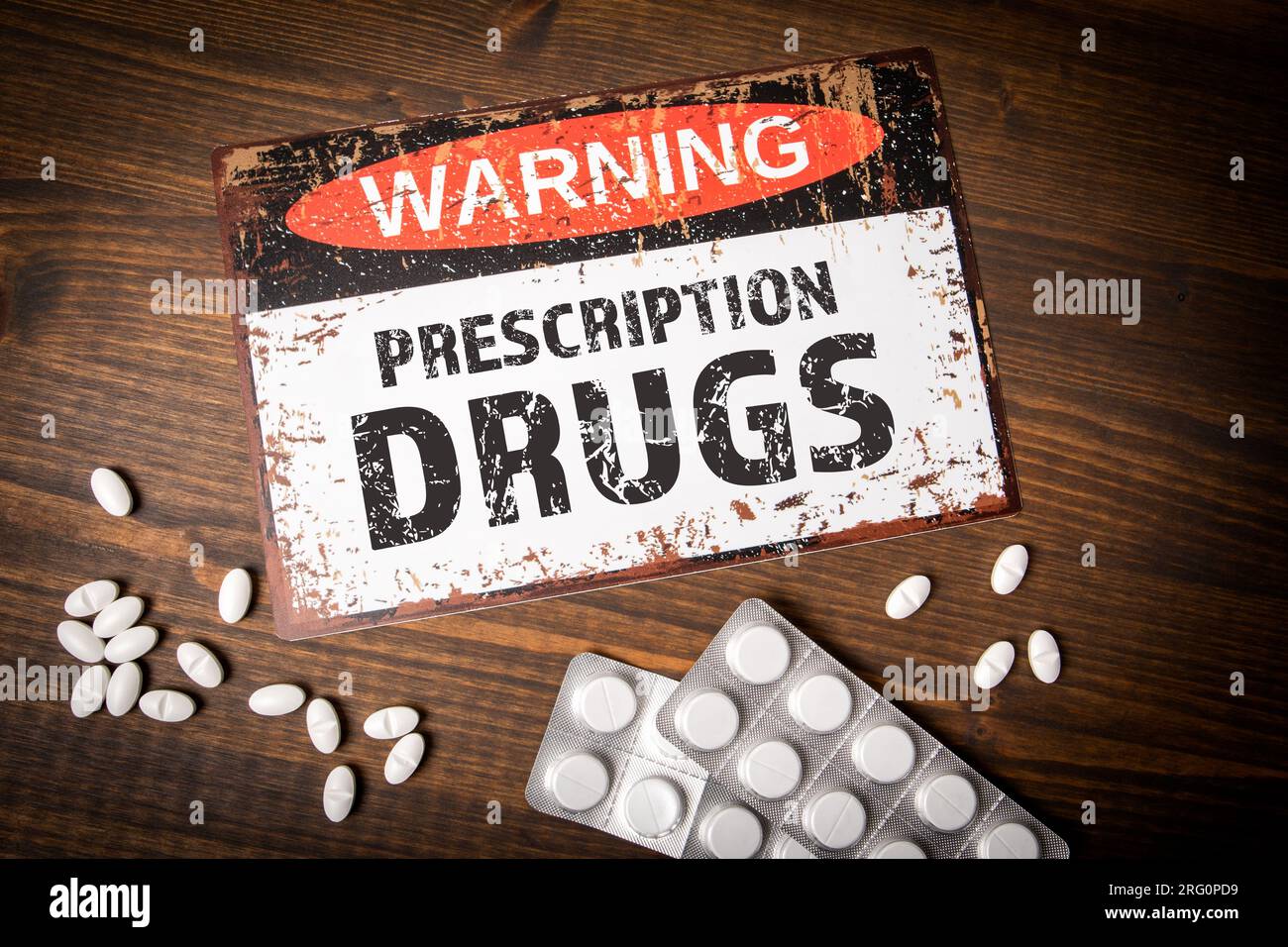 PRESCRIPTION DRUGS. Warning sign with text on wood texture background Stock Photo - Alamy