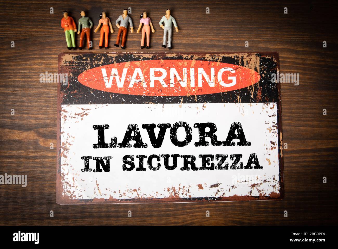 Work safety. Text in Italian on the warning sign. Wood Texture ...