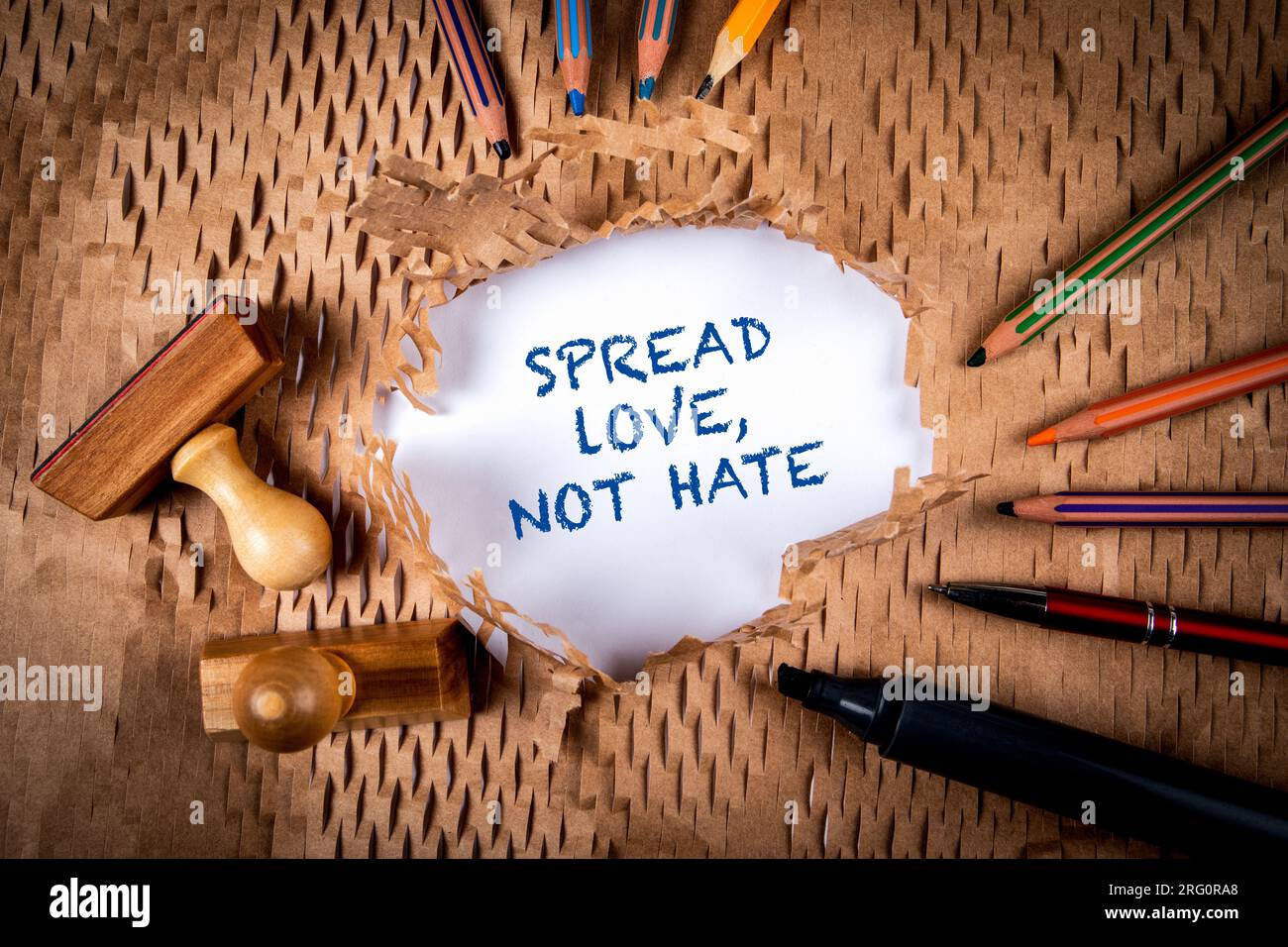 Spread love, not hate. Torn cardboard paper and office supplies Stock ...