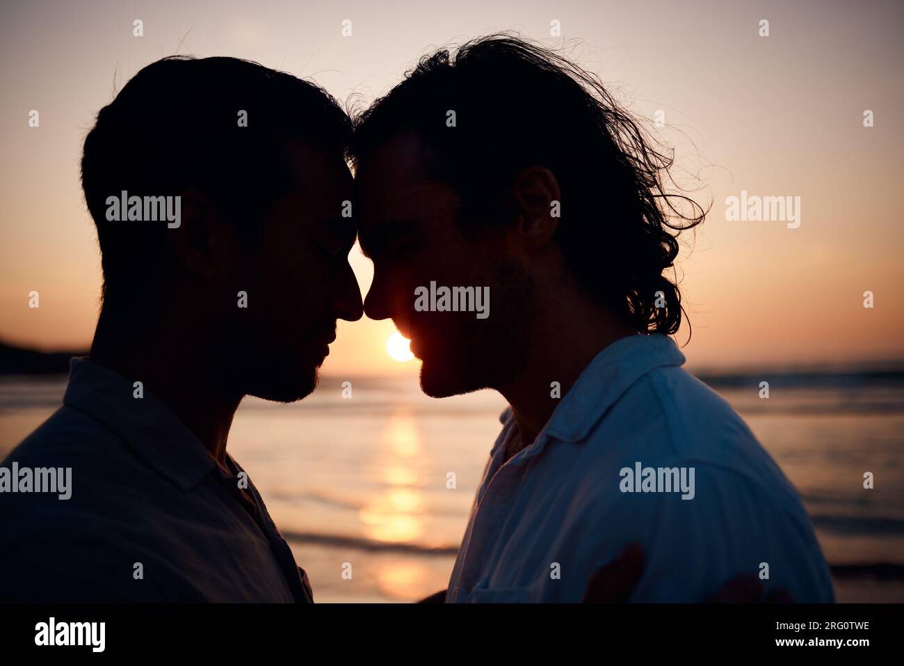 Beach, sunset and gay couple in silhouette, embrace and love on summer ...