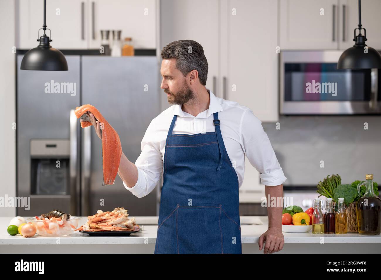 chef man cooking fish in the restaurant kitchen. photo of chef man ...