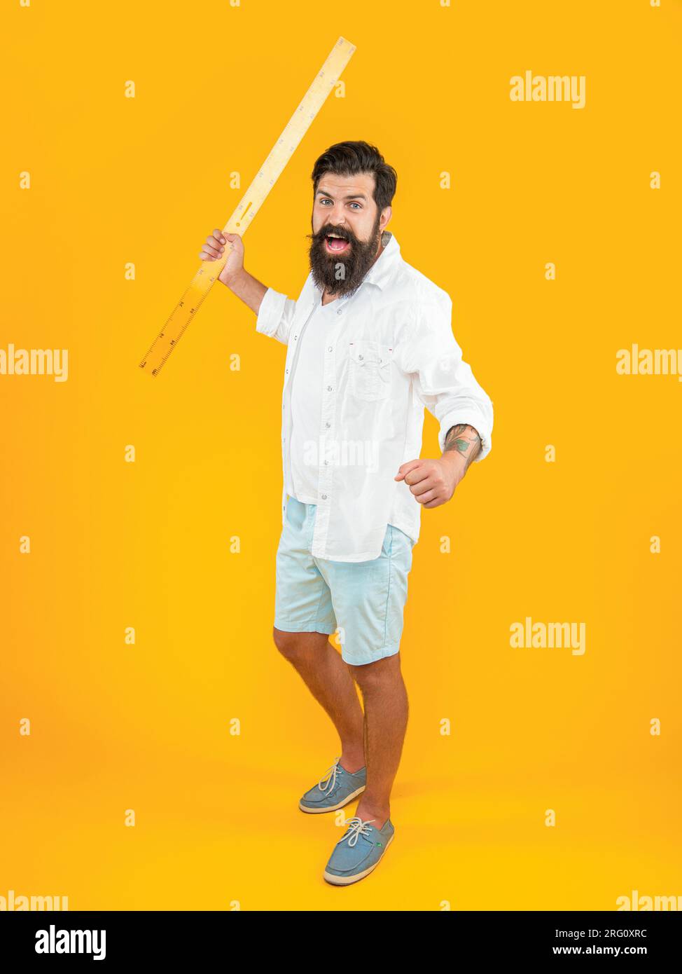 angry man with measuring ruler isolated on yellow. man with measuring ...