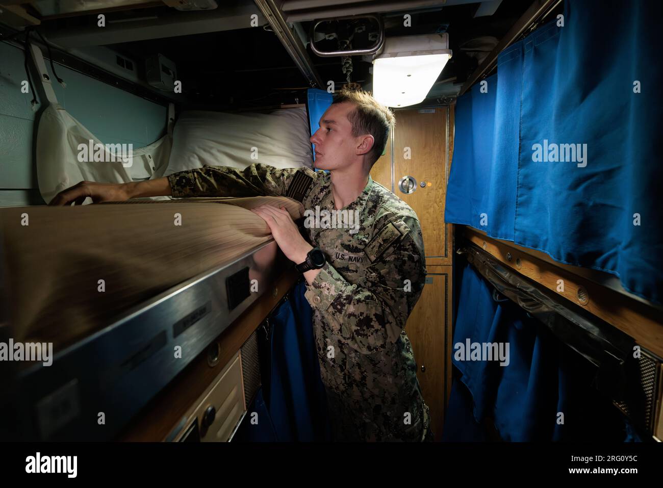 A crew member is seen in one of the six bunk berthing areas onboard the ...