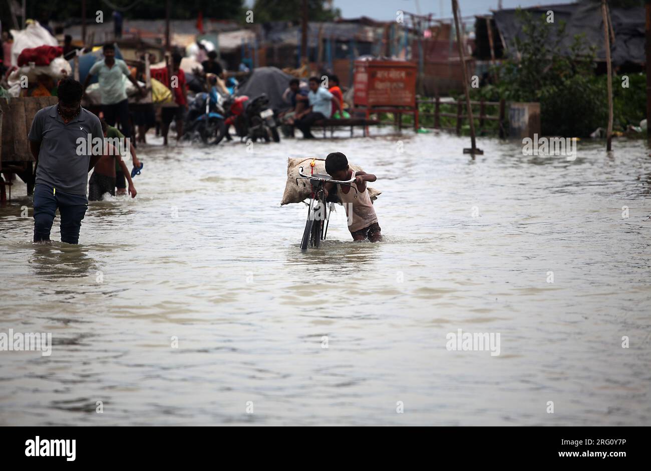 People prepare to shift at a safer place as water level of river Ganges ...
