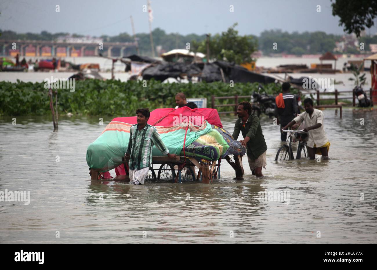 People prepare to shift at a safer place as water level of river Ganges ...